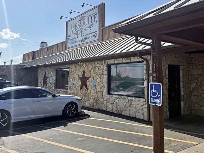 That rustic stone exterior and metal roof whisper "authentic Texas barbecue" louder than any billboard ever could.