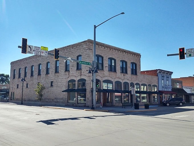 That classic brick corner building has seen generations pass by, standing proud like a monument to small-town permanence.
