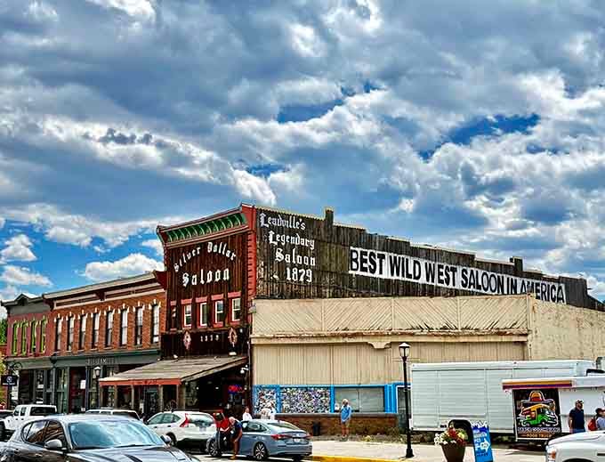 That weathered wooden facade has witnessed more Colorado history than most textbooks could ever capture in words.