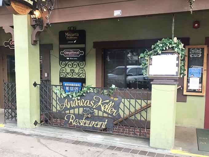 That charming entrance with its wrought-iron gate whispers promises of schnitzel and gem&uuml;tlichkeit waiting just beyond the threshold.