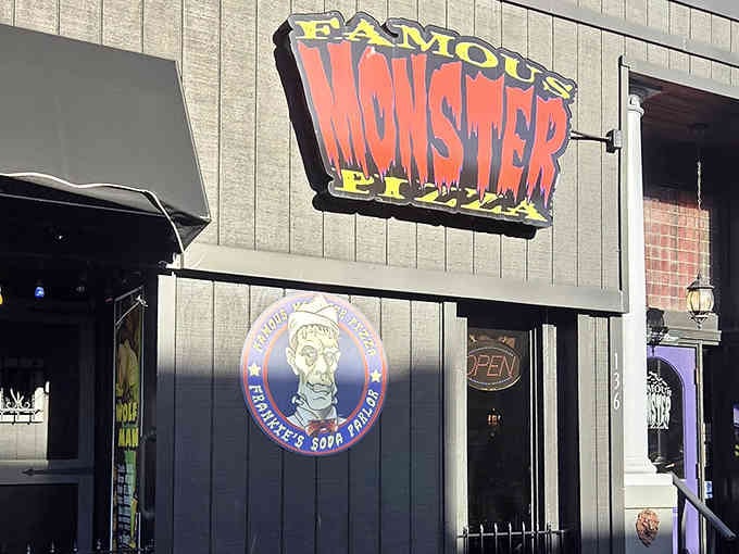 The Famous Monster Pizza storefront proves that purple doors and horror themes belong together in perfect harmony.
