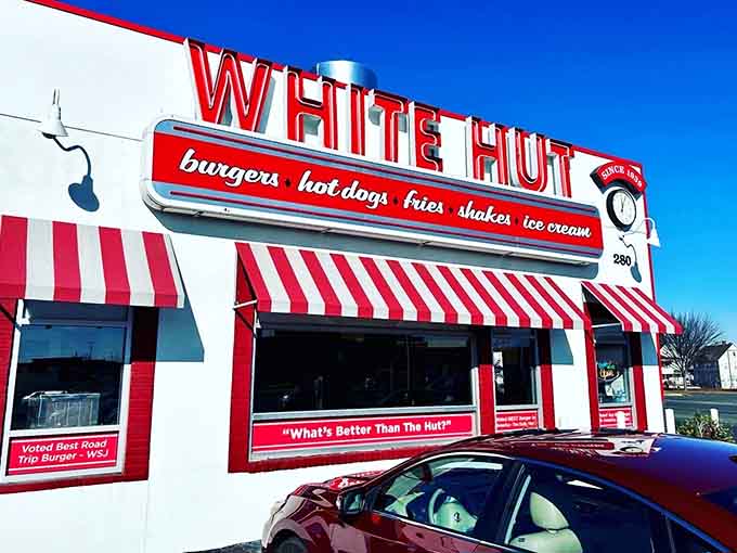 That iconic red and white striped awning has been calling hungry travelers like a siren song for generations.