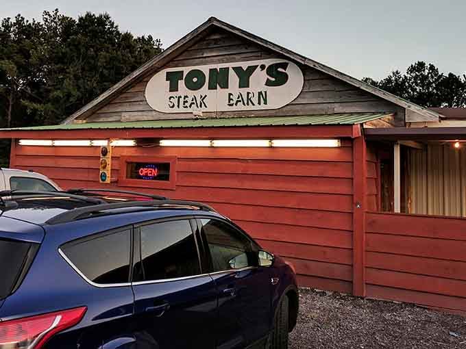 That rustic red barn exterior isn't just charming, it's your beacon to beef paradise in the Alabama countryside.