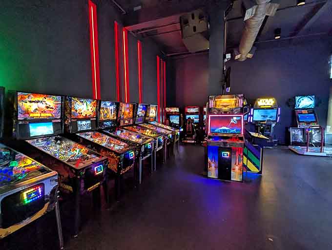 Those red neon strips frame pinball paradise like a Vegas showroom designed by someone who actually understands fun.