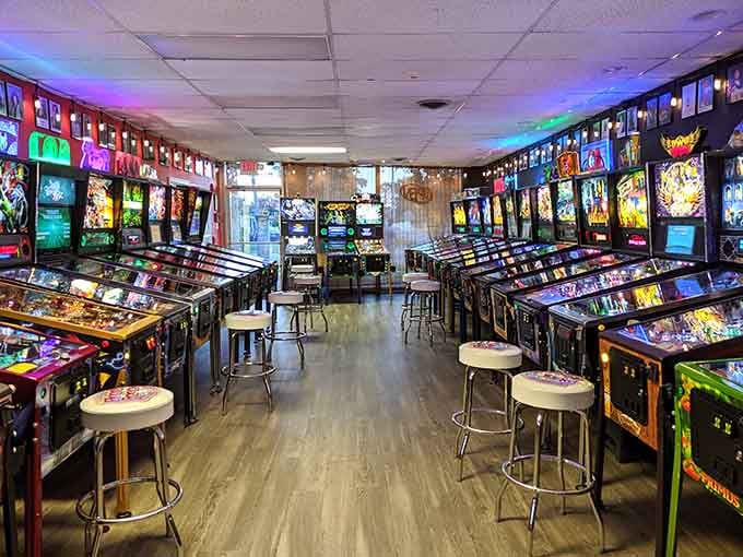 Rows of glowing pinball machines stretch like a neon dream, each one begging for your attention.