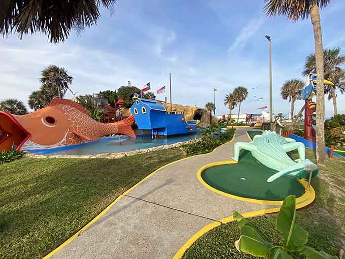 Giant fish, a smiling boat, and palm trees create the kind of whimsical chaos where keeping score becomes completely optional.