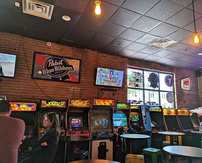 Classic arcade cabinets lined up like old friends waiting to reconnect over cold beers and hot competition.