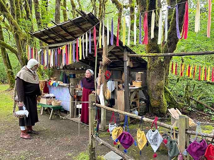 Medieval merchants peddle their wares beneath moss-draped trees, proving Washington's time-travel tourism is surprisingly authentic.