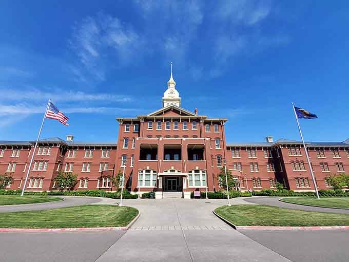 The imposing red brick facade looks almost inviting until you remember what happened inside those walls.