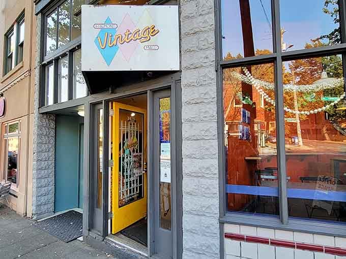 That cheerful sign beckons you inside like a friendly wave from a more colorful era.