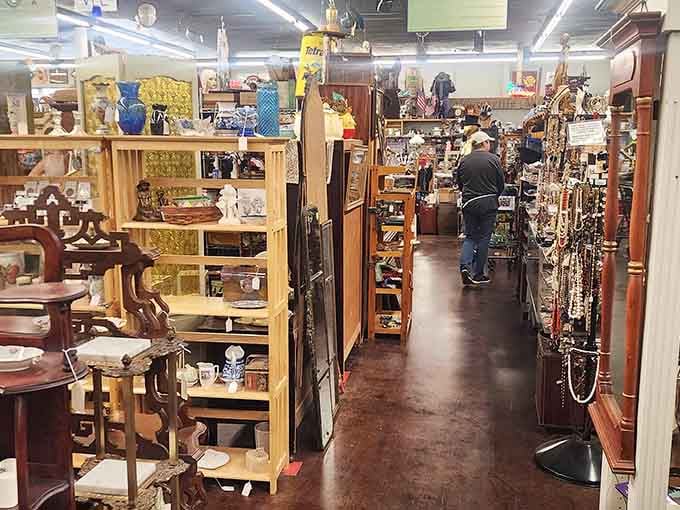 That bright blue vase catches the light like a beacon, guiding treasure hunters through endless rows of nostalgic discoveries.
