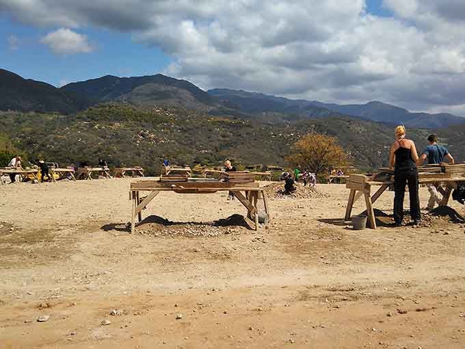 Those wooden screening tables against mountain vistas look like a prospector's dream from a classic Western film.