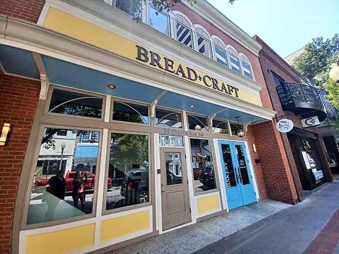 That cheerful yellow and blue storefront is basically waving you inside for buttery croissants and strong coffee.