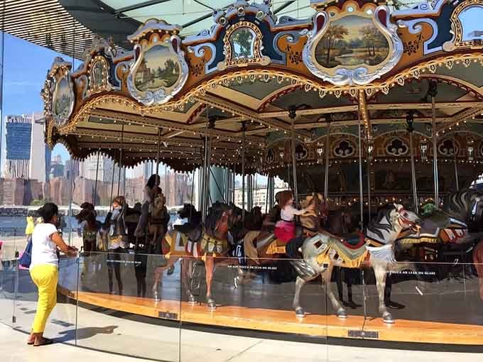 Hand-carved horses frozen mid-gallop, each one a masterpiece that's been spinning since the Roaring Twenties.