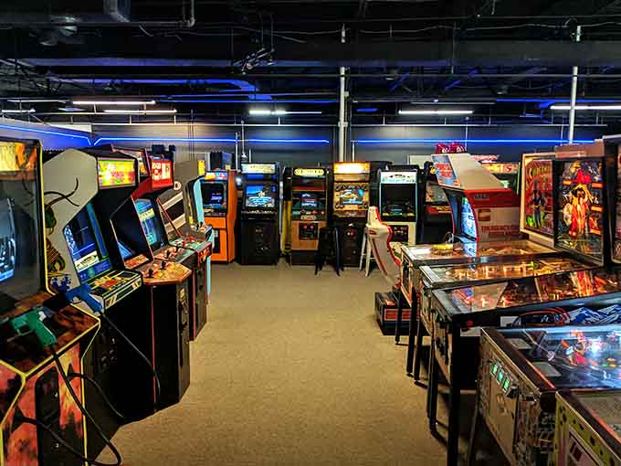 Rows of glowing cabinets stand ready like soldiers of joy, each one promising a different adventure into gaming's golden age.
