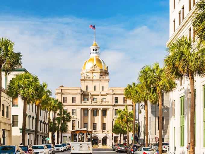 City Hall stands proud behind palm trees while trolleys roll past, blending Southern charm with practical transportation.