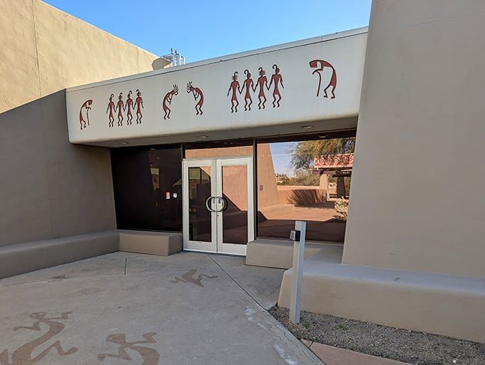 Ancient storytelling meets modern architecture where Hohokam figures dance across the entrance, welcoming you to their world.