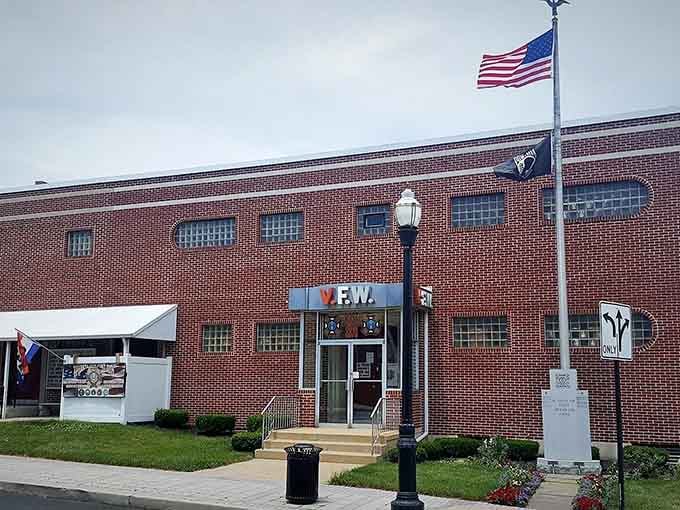 That red brick facade and Old Glory flying high signal something special: authentic American comfort food awaits inside.