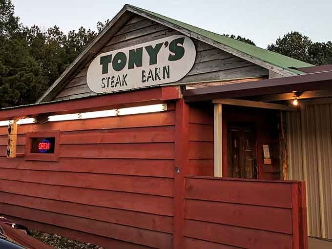 That rustic red barn exterior isn't just charming, it's your beacon to beef paradise in the Alabama countryside.