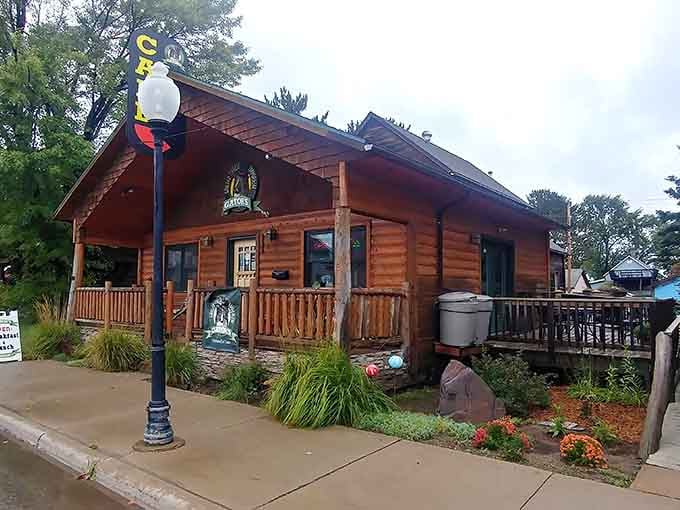That charming log cabin exterior promises comfort food magic waiting inside those rustic northwoods walls.