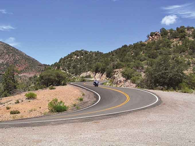 Those curves aren't just suggestions, they're invitations to one of Arizona's most thrilling mountain adventures.