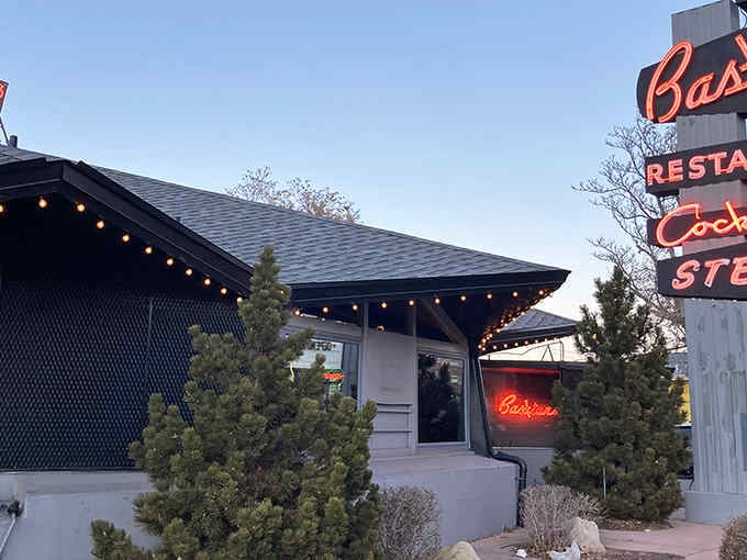 String lights outline the entrance like a runway to steak paradise, while that neon glow promises everything wonderful inside.