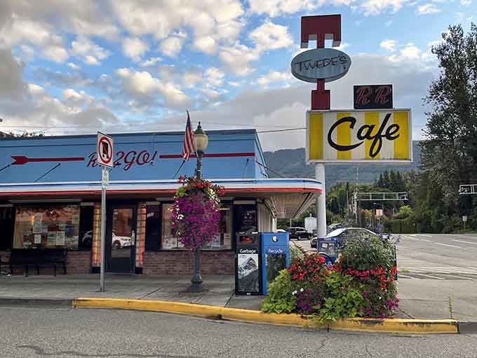 That retro signage against mountain peaks proves some things just belong together, like coffee and mornings.