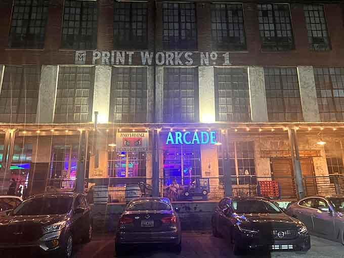 That glowing "ARCADE" sign against the historic Print Works facade proves old buildings can absolutely learn spectacular new tricks.