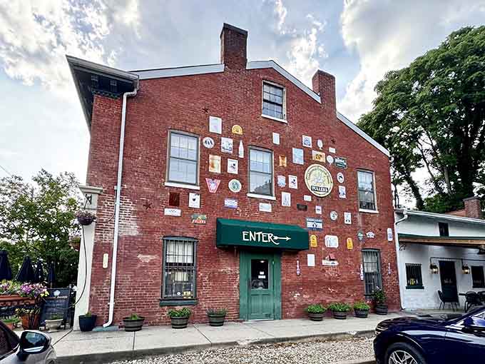That red brick facade covered in pub signs tells you everything: this place has stories to share.