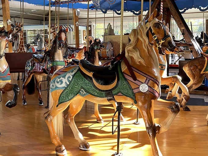 Hand-carved wooden horses frozen mid-gallop, each one a masterpiece that puts modern assembly-line carousels to shame.