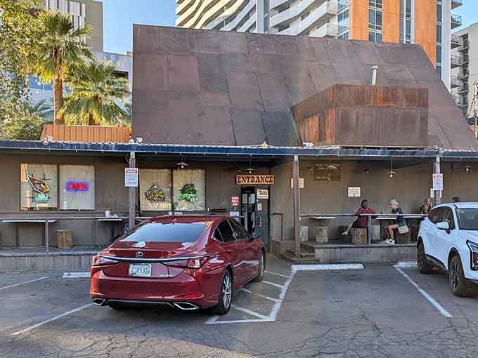 A humble shack surrounded by gleaming towers, proving that real value isn't measured in square footage.