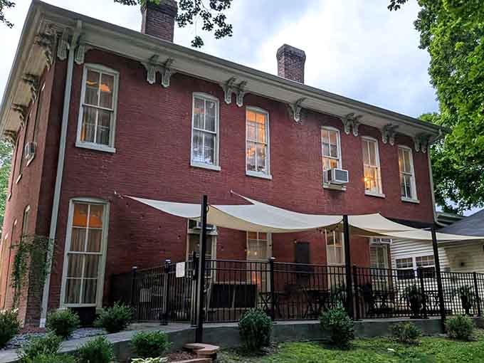 That red brick facade practically glows with Southern hospitality, promising comfort food treasures hidden inside those historic walls.