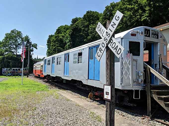 That railroad crossing sign isn't just for show; these trolleys actually glide along authentic tracks through Kingston.