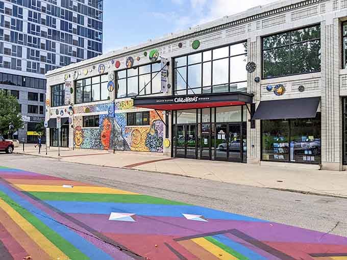 That vibrant rainbow crosswalk leading to adventure proves even the sidewalk knows where the fun begins.