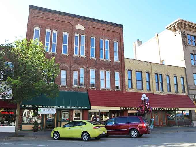 Historic storefronts line up like old friends, their brick facades telling stories that modern strip malls could never match.