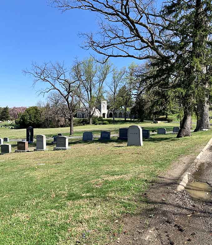Rolling hills and towering trees create a landscape more peaceful park than somber cemetery grounds.