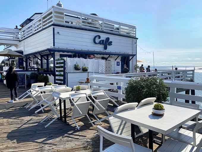 The iconic white building at pier's end beckons like a lighthouse for hungry souls seeking coastal bliss.