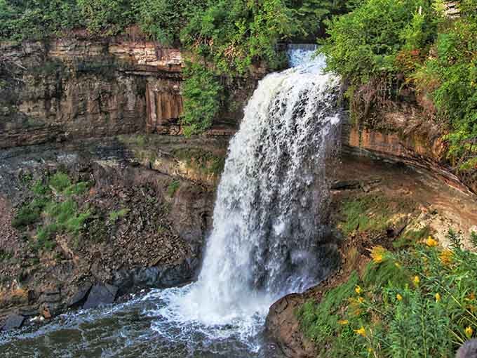 The layered rock walls tell a geological story millions of years old, while water writes today's chapter.