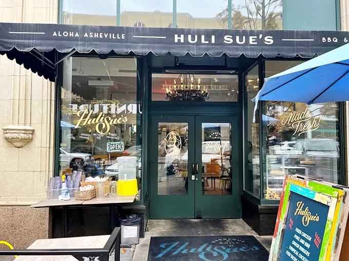 That "Aloha Asheville" awning isn't lying, this storefront promises a tropical escape with serious barbecue credentials.