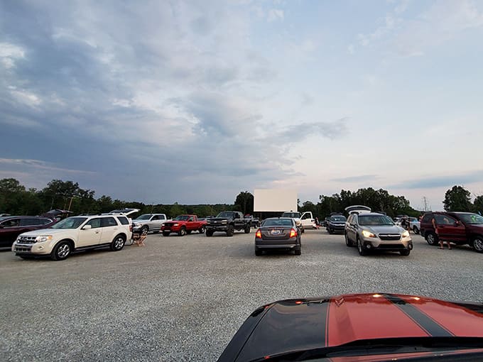 Rows of cars face the towering screen as twilight paints the Kentucky sky in shades of pink and blue.