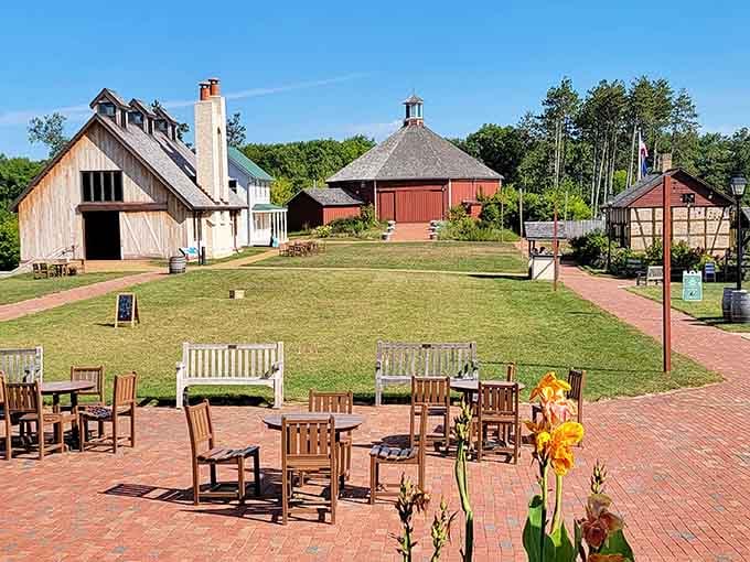 Historic farm buildings cluster like a 19th-century neighborhood where WiFi would've seemed like actual witchcraft.