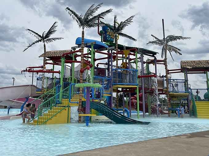 This multi-level splash fortress looks like someone's fever dream of tropical paradise, complete with palm trees and chaos.