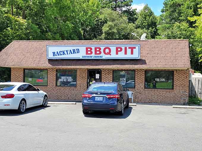 That modest brick facade hides some of Durham's most sought-after barbecue, where the real magic happens out back.