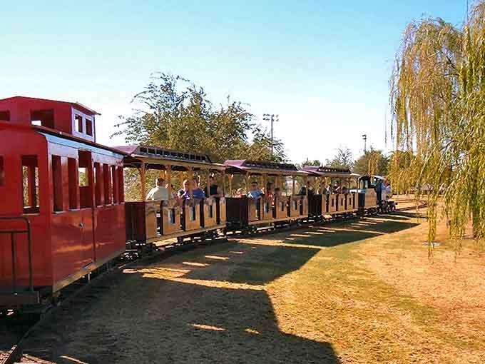 The train cars stretch out like a promise of simple pleasures, waiting to carry you through desert scenery at the perfect pace.