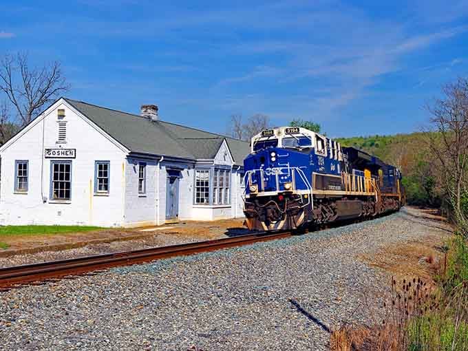 That classic white depot and rumbling freight train prove small-town America still has serious charm to spare.