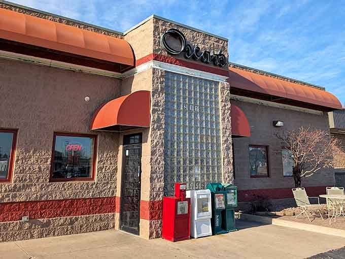 That stone facade and cheerful awning promise serious breakfast business, like a superhero's secret headquarters for pancakes.