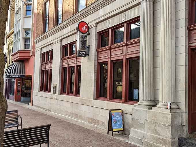 Those classic columns frame the entrance to pizza paradise on one of Madison's most iconic streets.