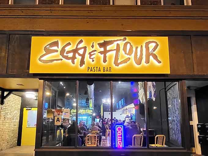 That yellow sign glows like a beacon of carb-loaded happiness against Milwaukee's historic brick buildings at night.