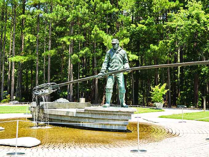 A bronze fisherman casting his line over a fountain, proving that art and patience go hand in hand.