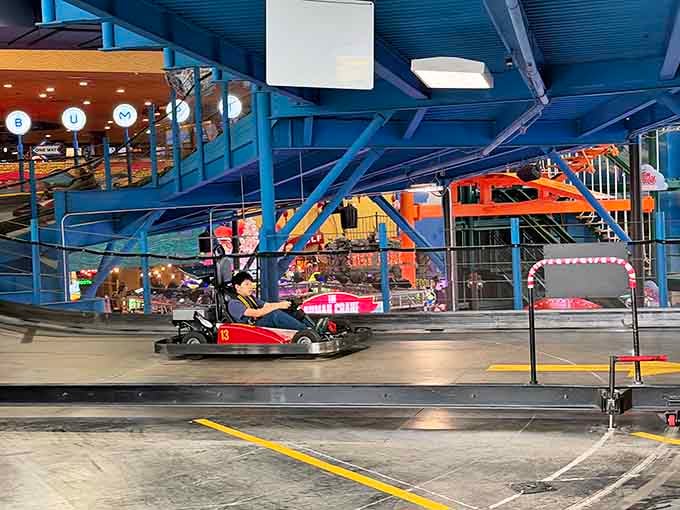That elevated go-kart track snaking through the building is basically your chance to live out racing fantasies without the speeding ticket.
